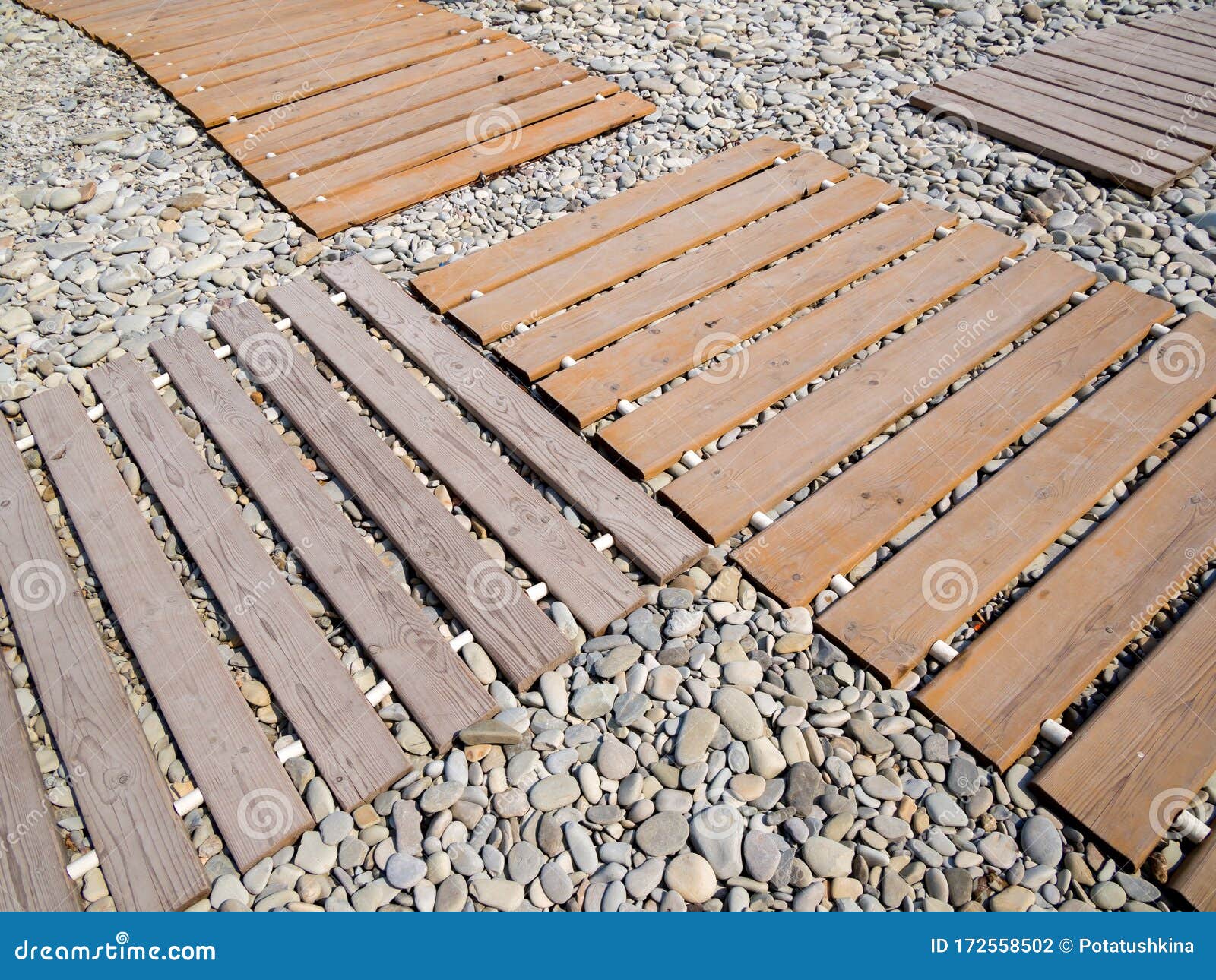 Paths of Wooden Slats on a Pebble Beach Stock Photo - Image of pebbles ...