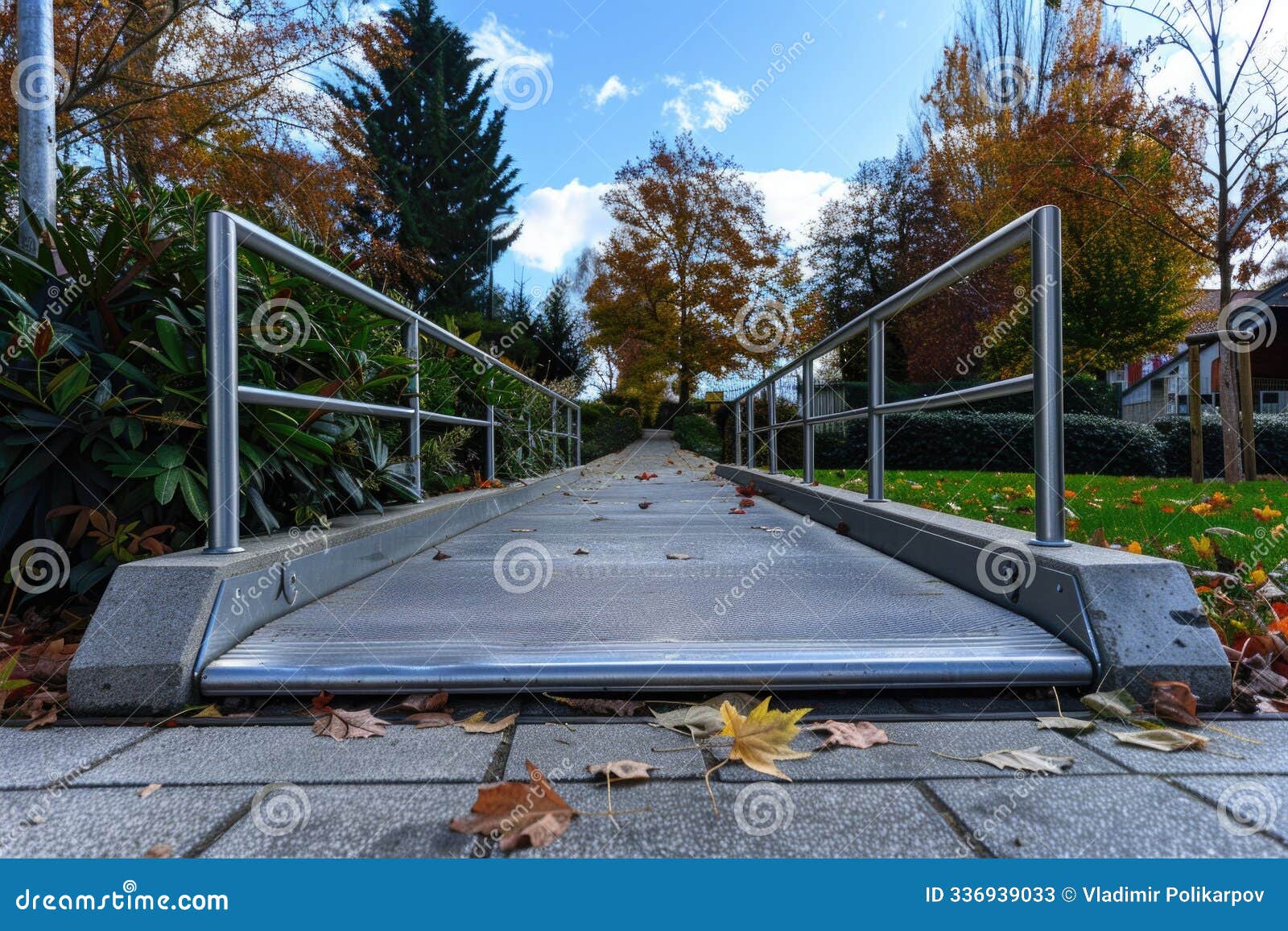 A Pathway Lined with Metal Railings and Covered in Fallen Leaves Stock ...