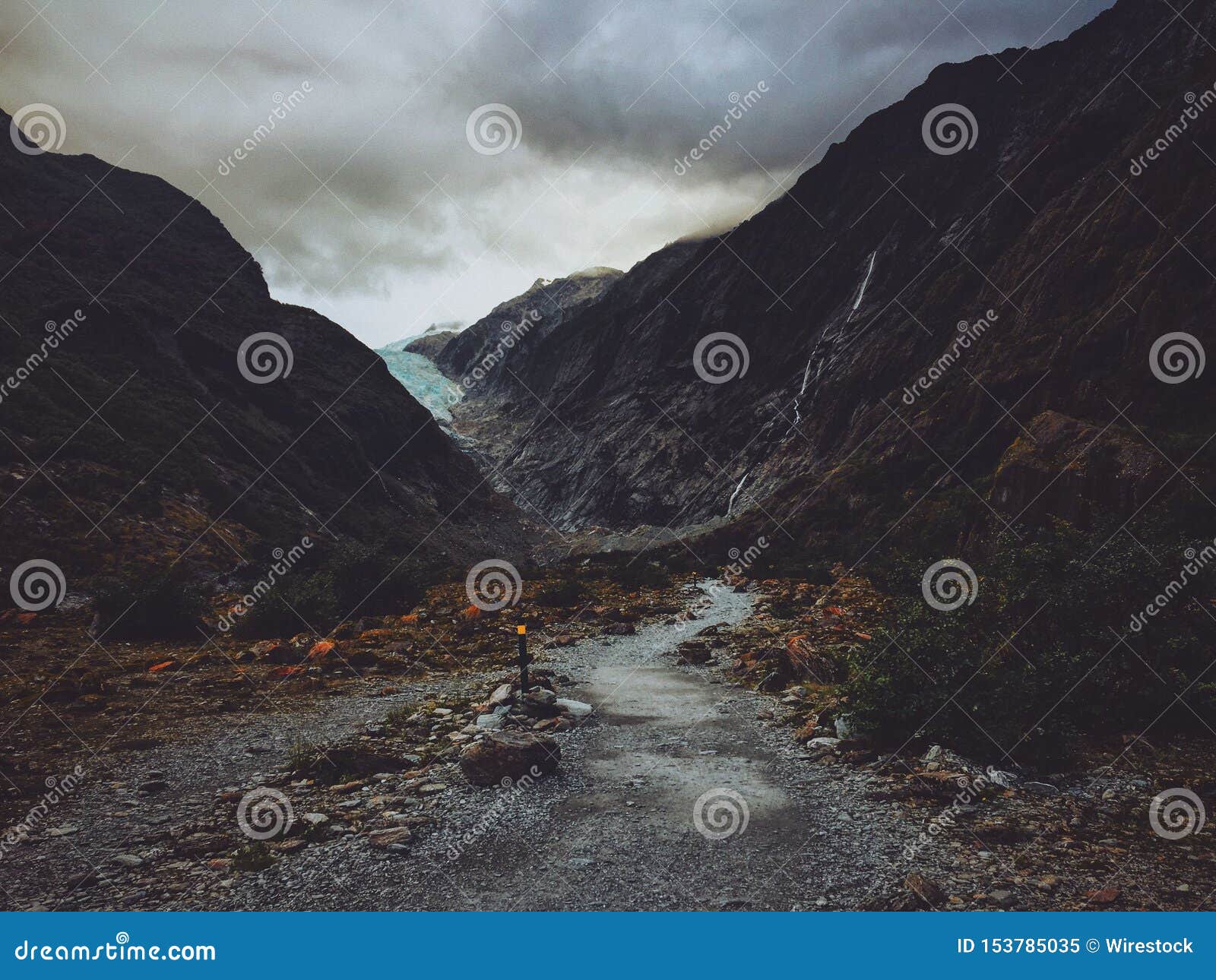 Pathway in the Middle of Two Mountains on a Cloudy Day Stock Image ...