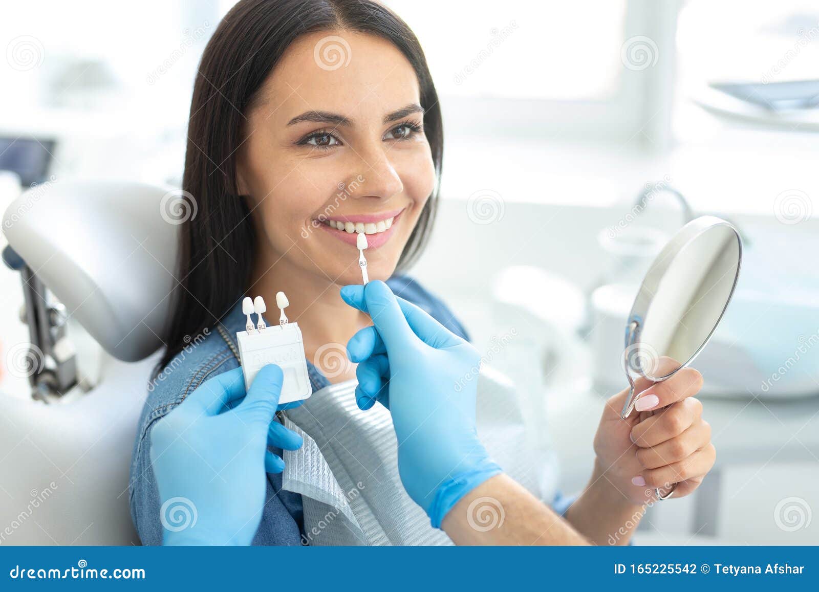 Patient Choosing Tooth Implants with Doctor in Clinic Stock Photo ...