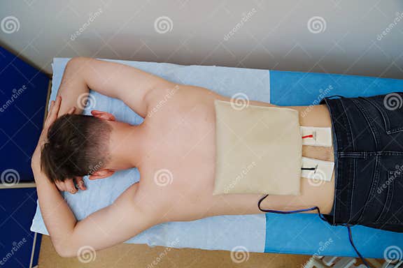 Patient with an Electrotherapy on the Back, Electrical Stimulation ...