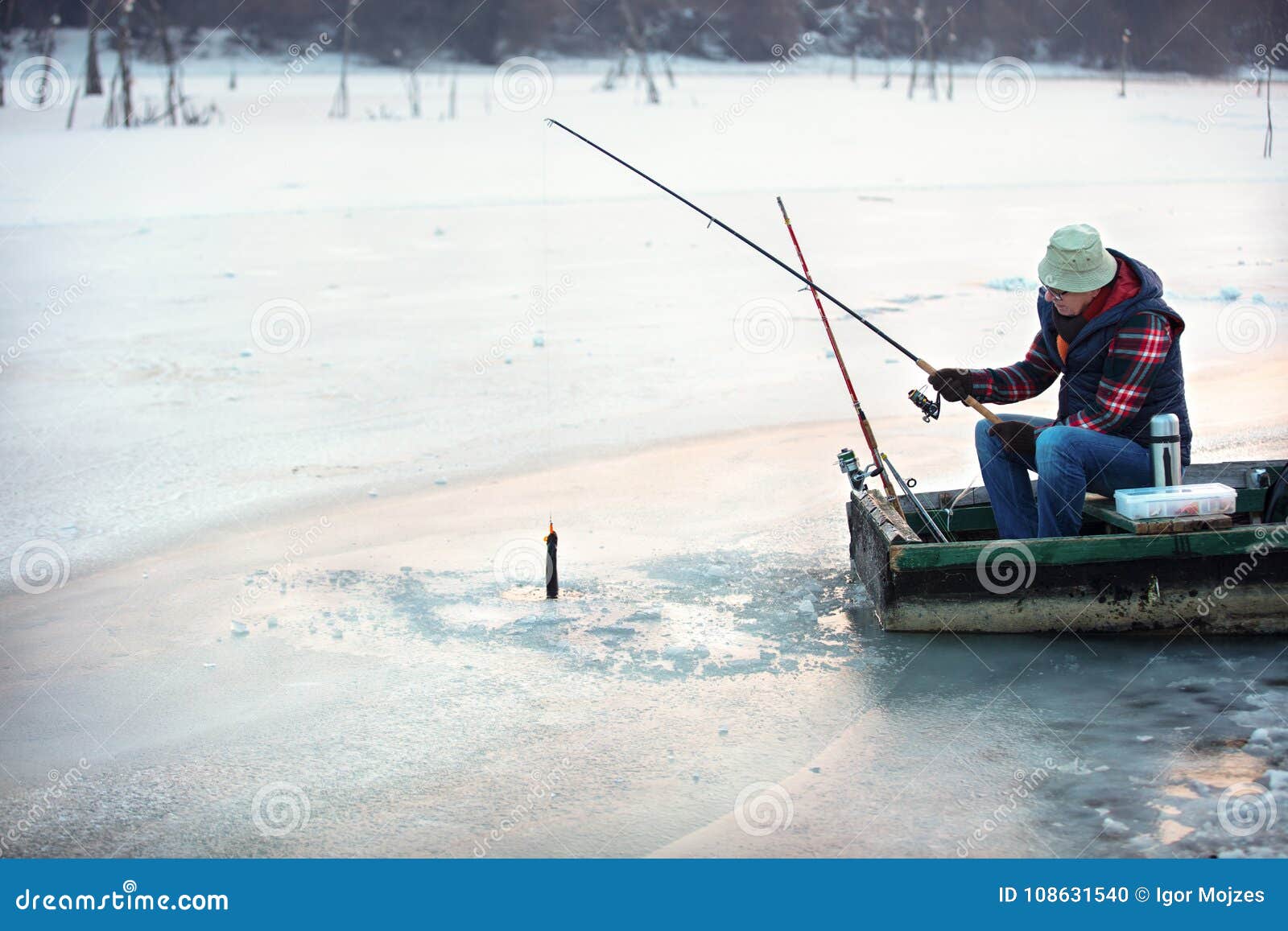 Patient Fisherman Pulls Hooked Fish from Water Stock Photo - Image of ...