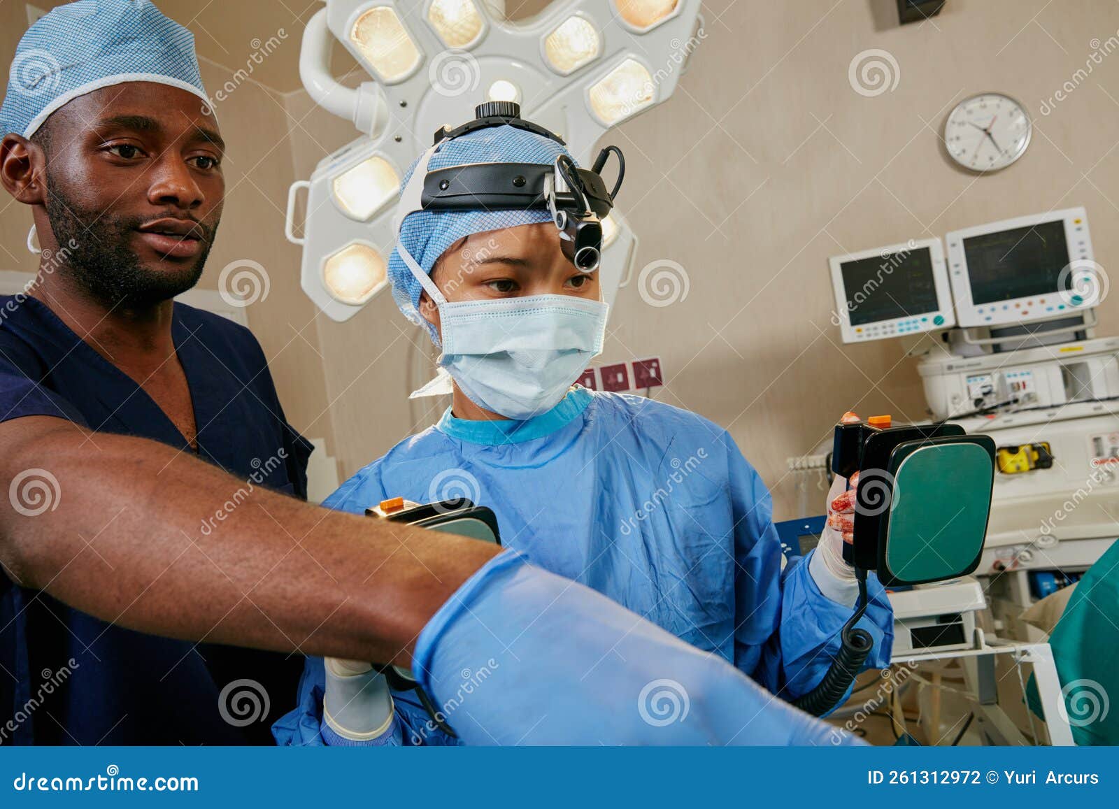 The Patient is Going into Defib. a Surgeon Using a Defibrillator on a ...