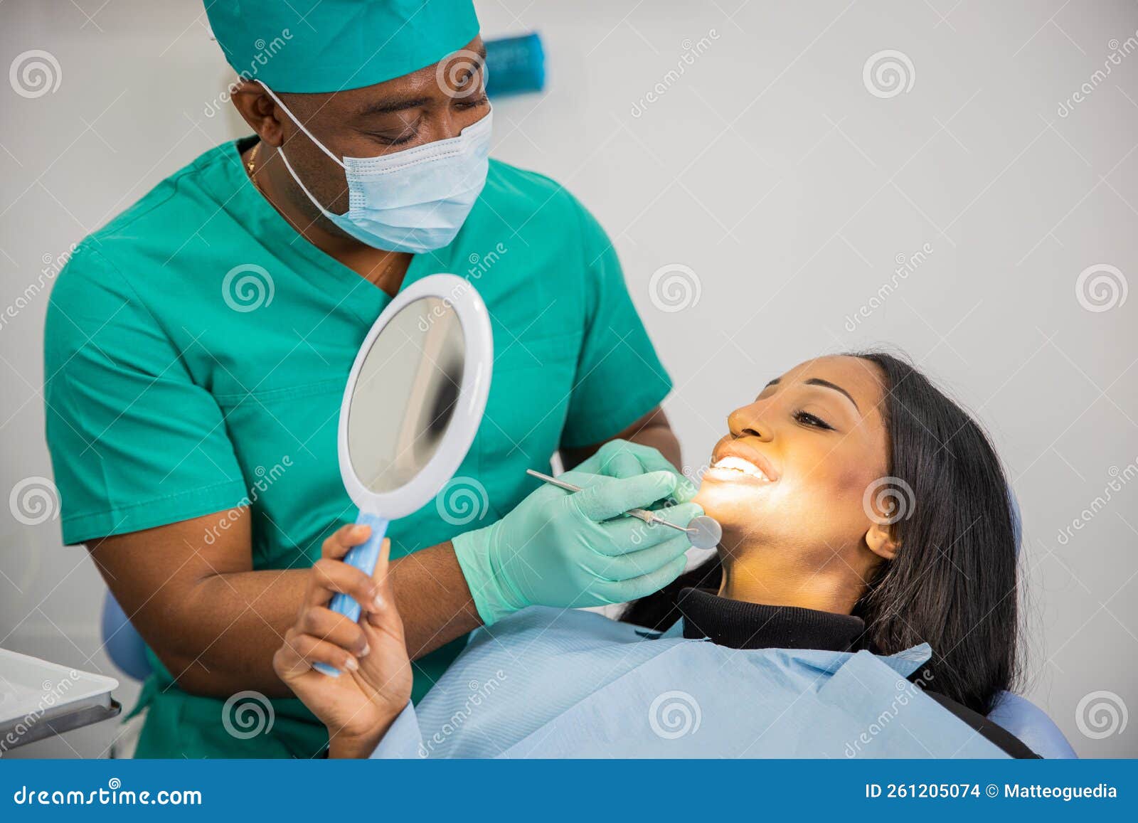 Patient Looks at His Teeth with the Mirror during a Dental Visit Stock ...