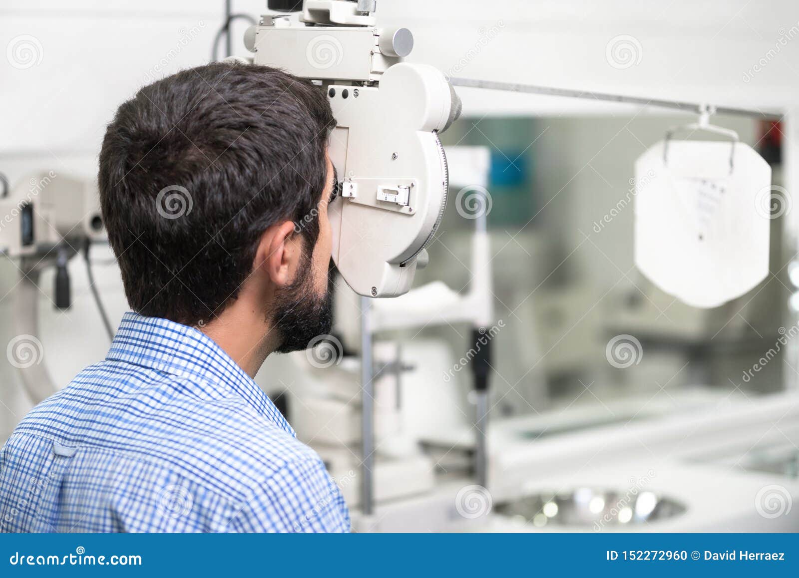 Patient is Reading the Optometrist Chart in Modern Ophthalmology Clinic ...