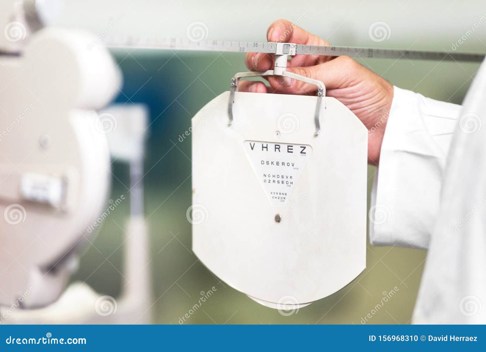 Patient is Reading the Optometrist Chart in Modern Ophthalmology Clinic ...