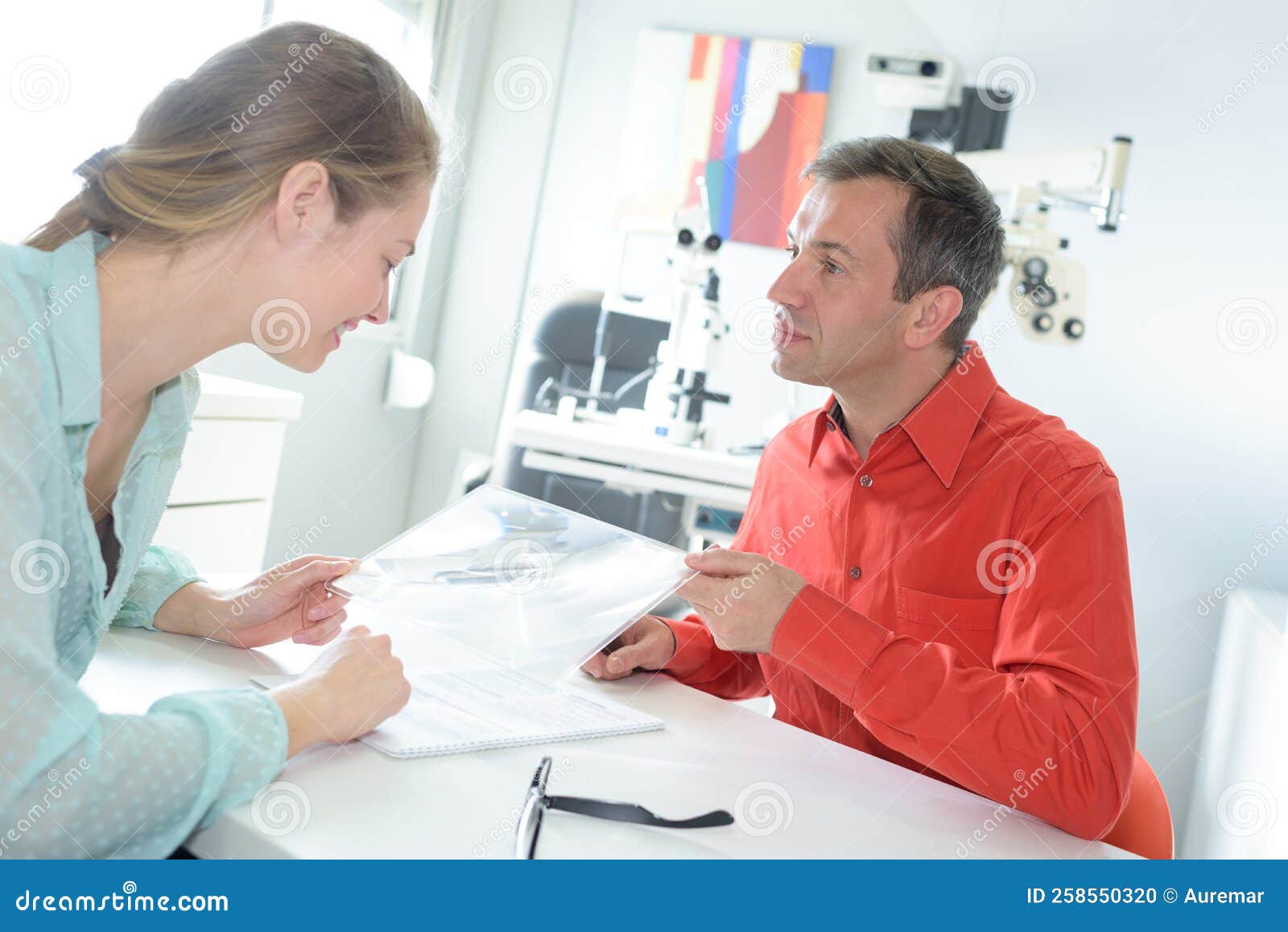 Patient Reading Text through Magnification Sheet during Opticians ...