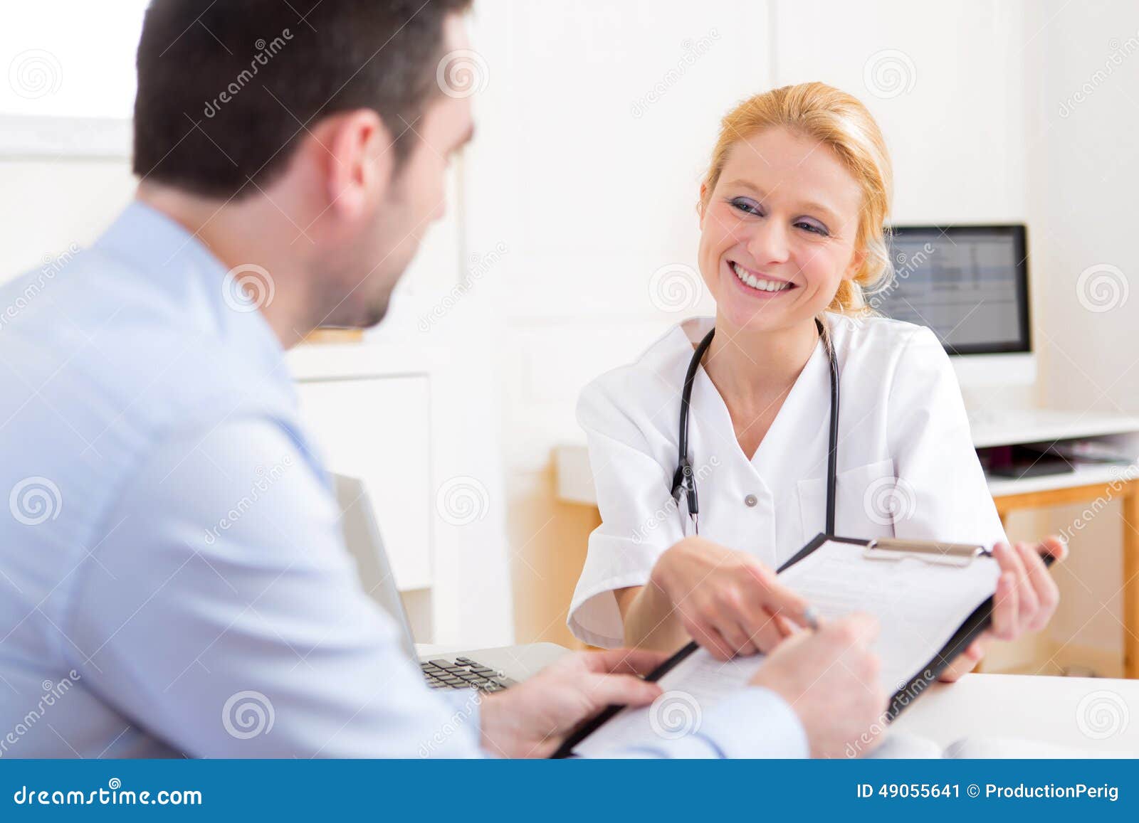 Patient Signing the Document of a Young Attractive Doctor Stock Image ...