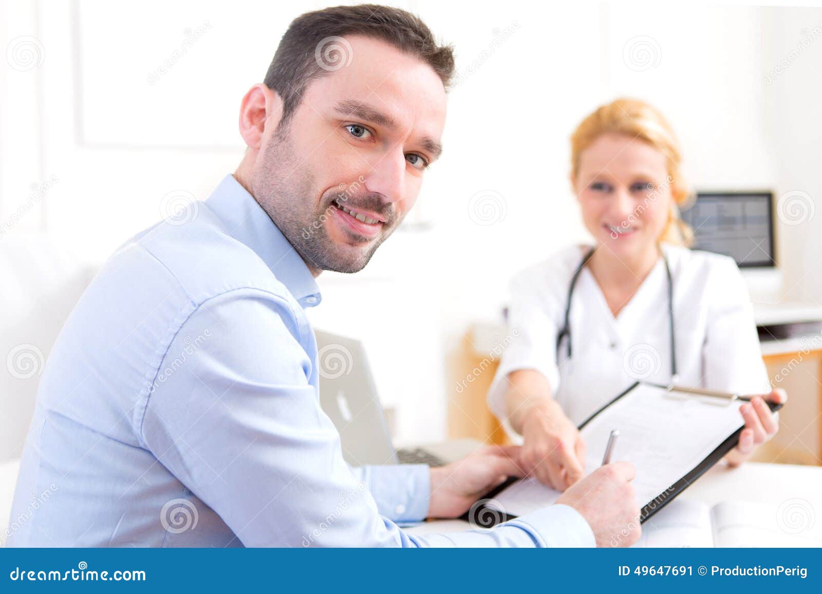 Patient Signing the Document of a Young Attractive Doctor Stock Image ...