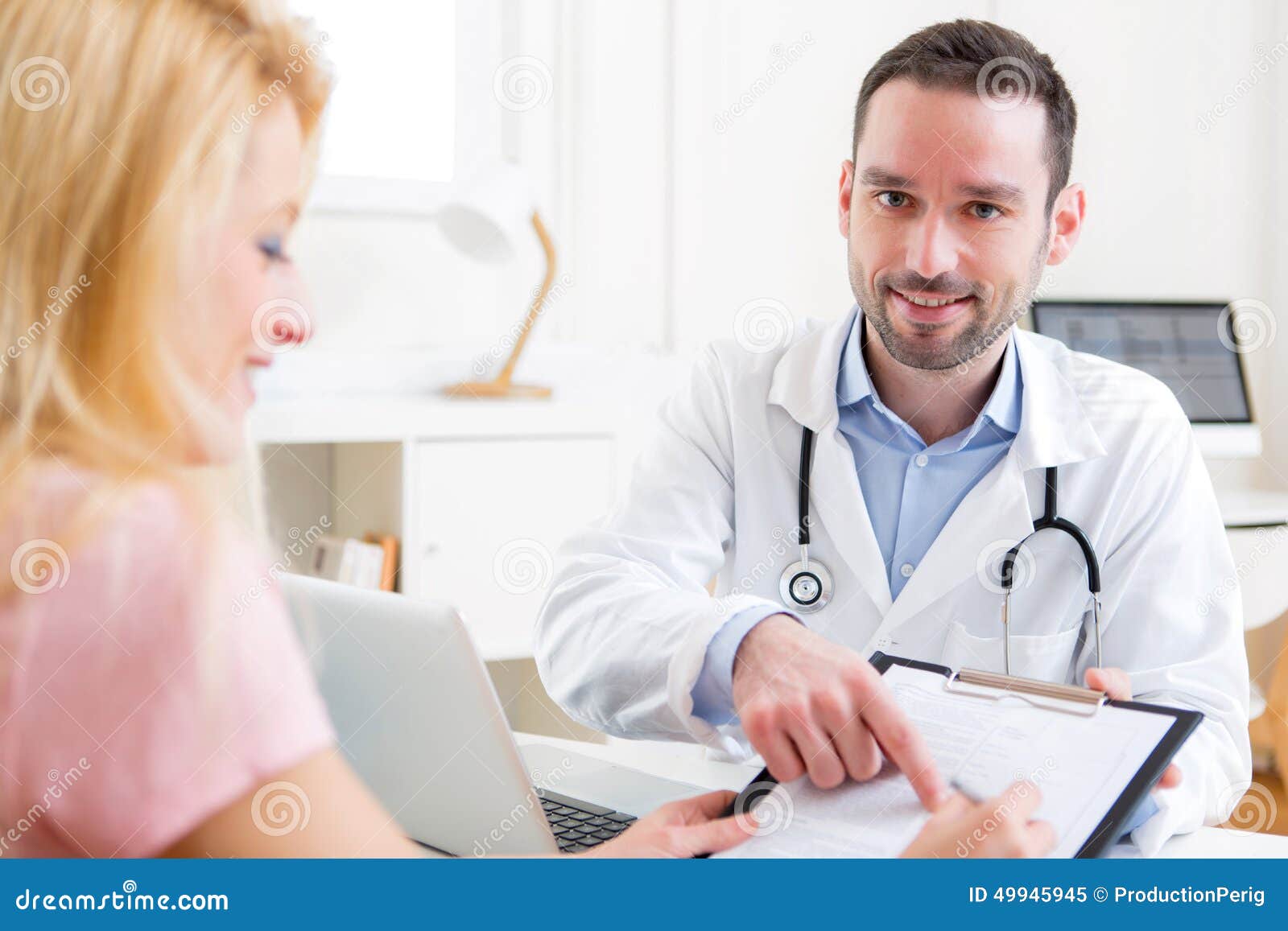 Patient Signing the Document of a Young Attractive Doctor Stock Image ...