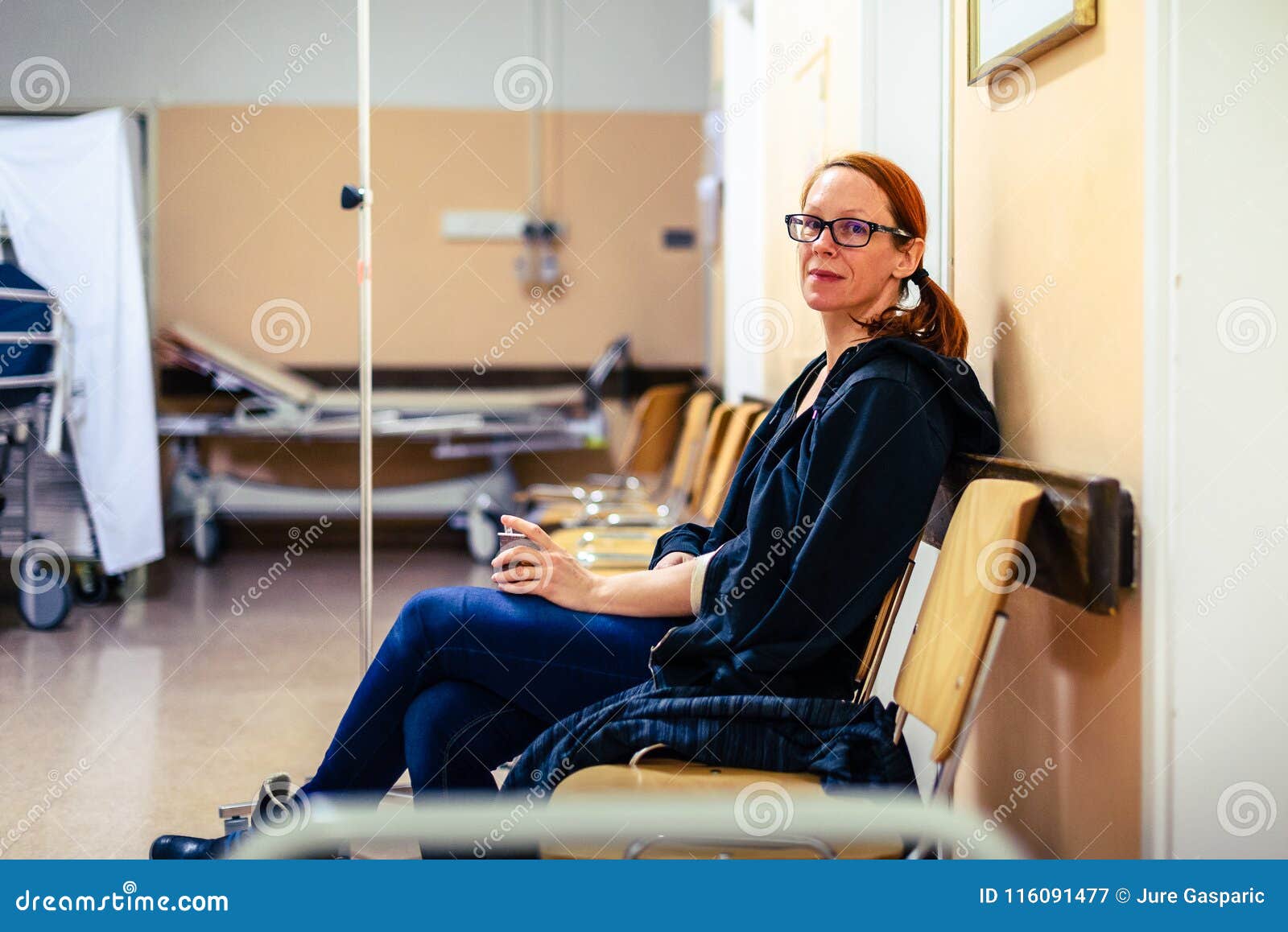 Patient Sitting In Hospital Ward Hallway Waiting Room With Iv Stock