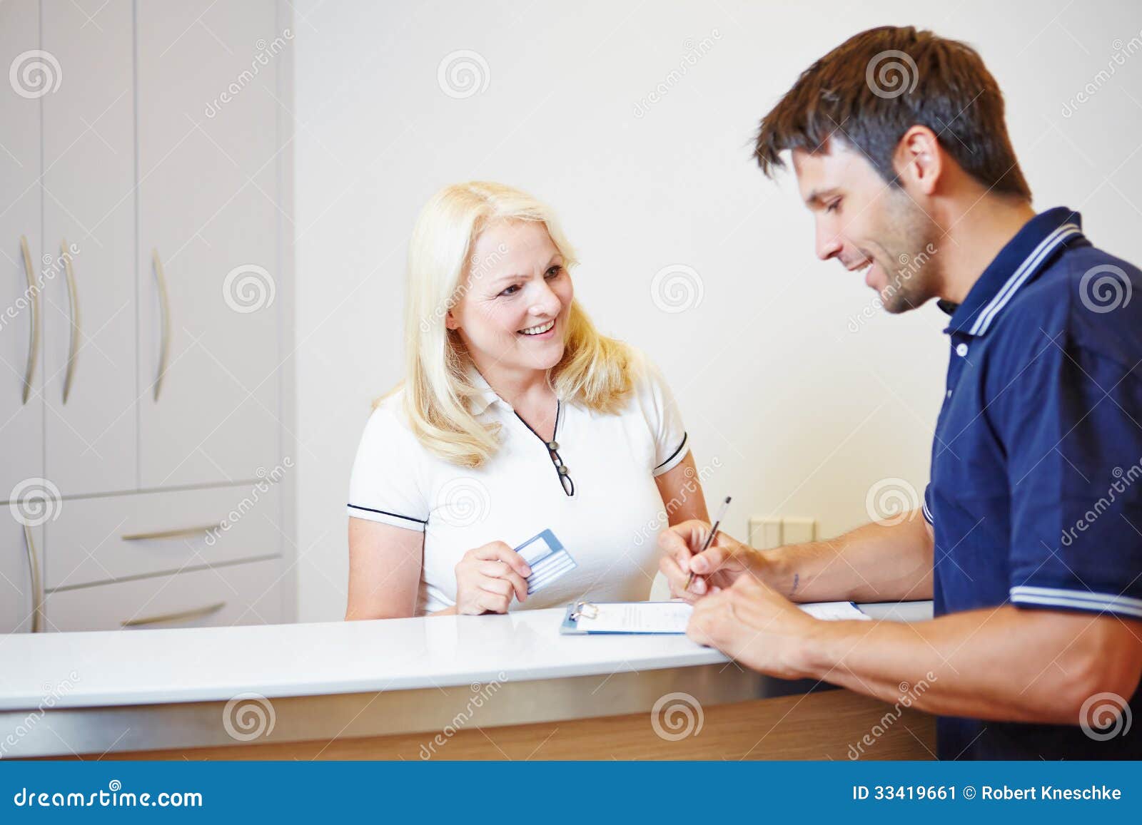 Patient Talking with Doctors Assistant at Reception Stock Image - Image ...