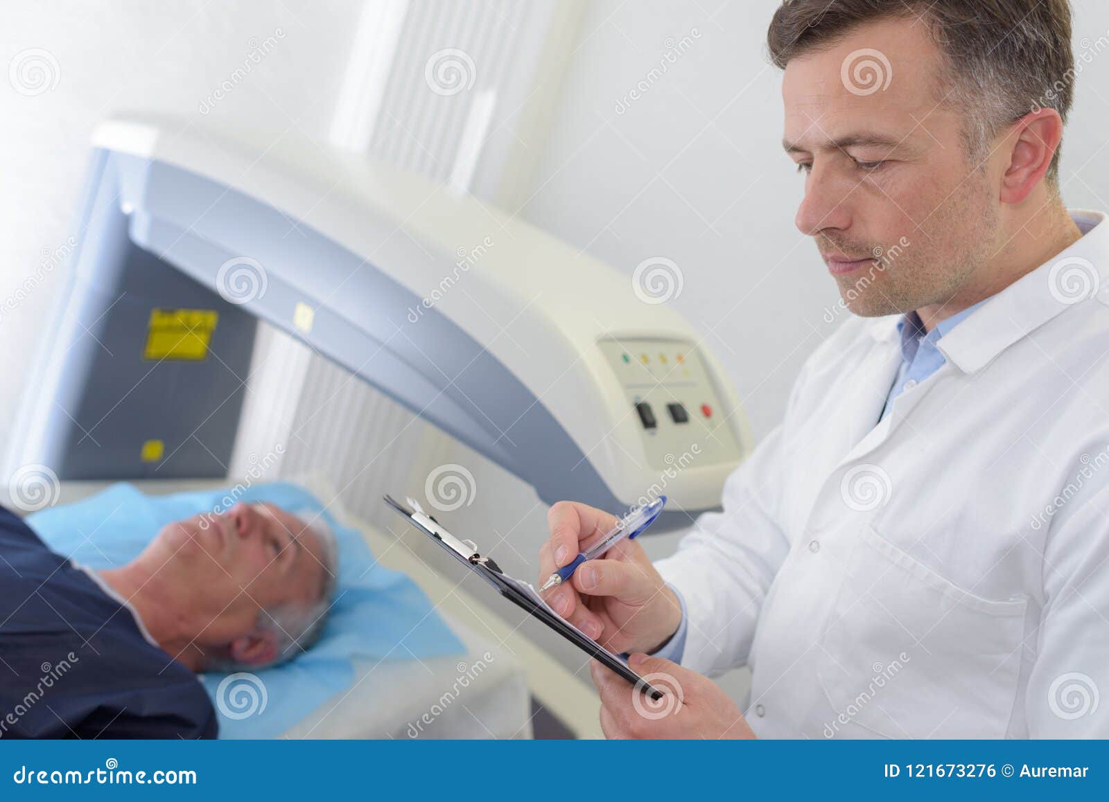 Patient on Xray Scanner Doctor Taking Notes Stock Photo - Image of ...