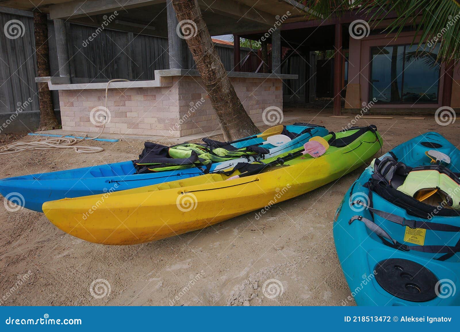 Patio with Kayaks on the Sand Under the Shade of Palm Trees. Stock ...