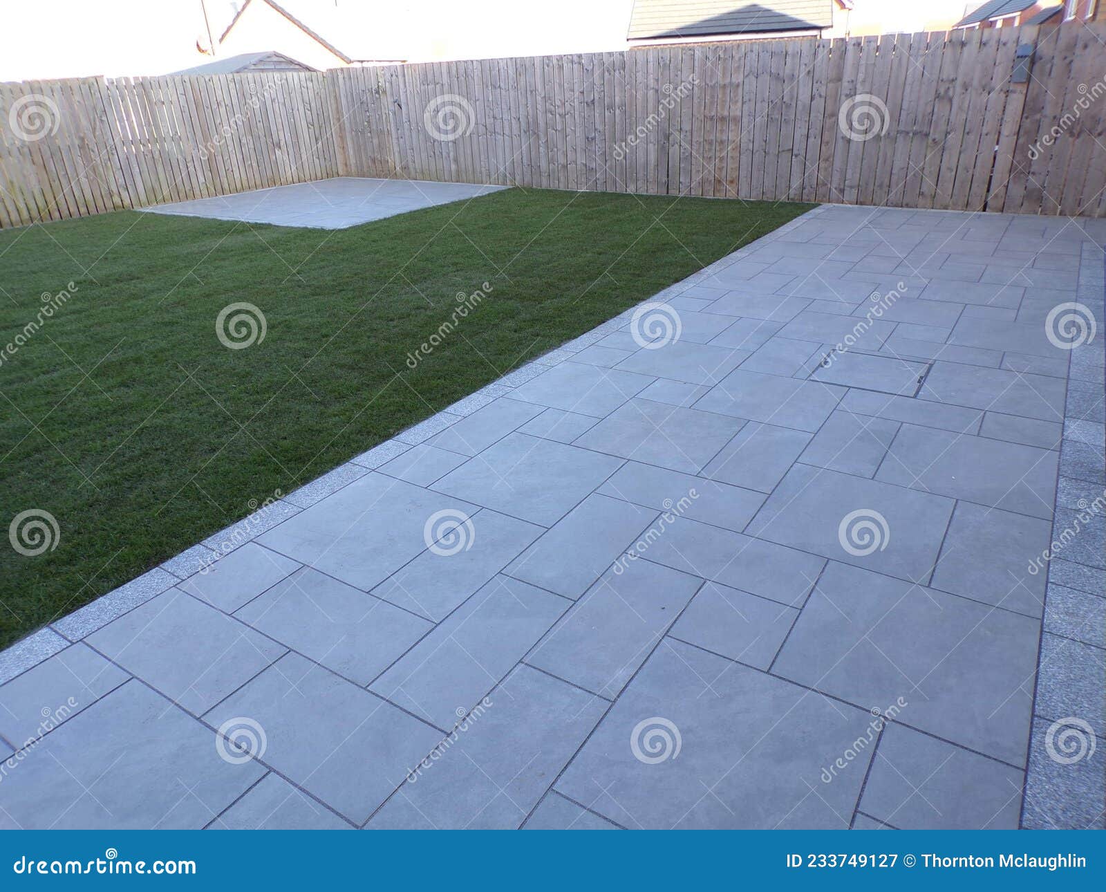 Patio tiles in fenced yard stock image. Image of house - 233749127