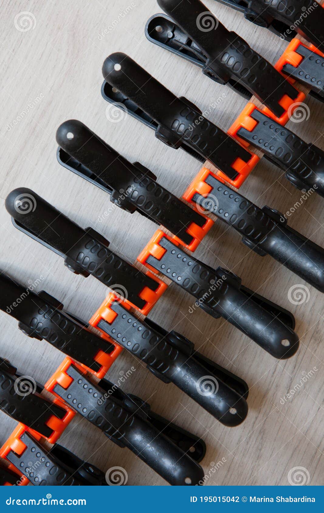 Abstract Pattern from Black and Orange Construction Clamps. Clamping ...