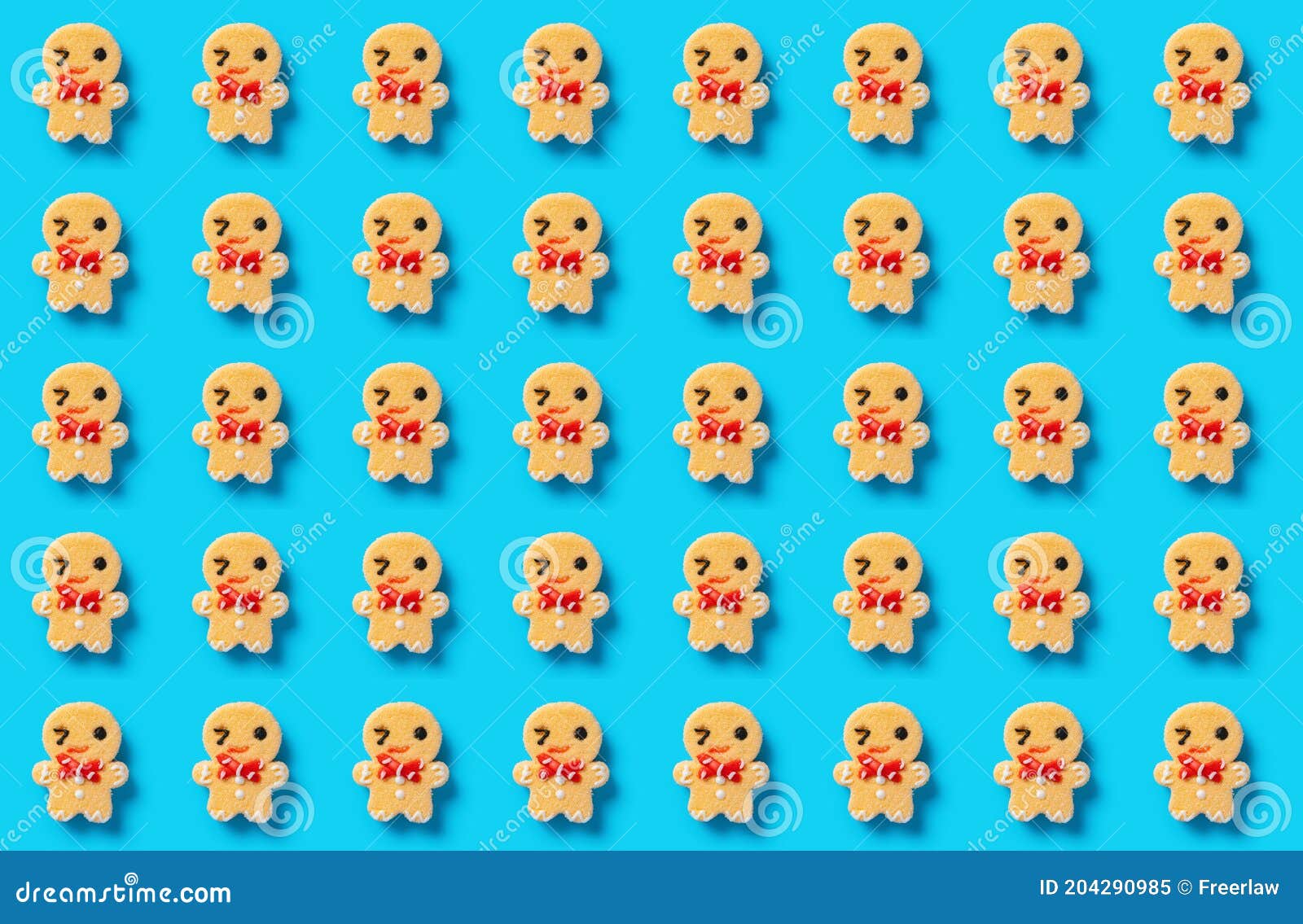 A Pattern of Cute Gingerbread Shape Candies on a Blue Background Stock ...