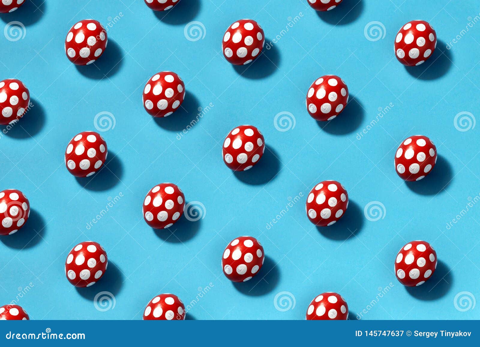 Pattern of Easter Eggs in Red with White Spots on a Blue Background ...