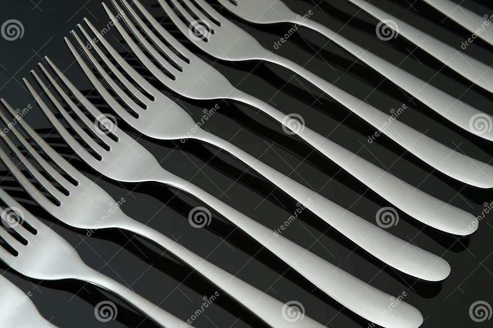 Pattern with Many Silver Forks on Black Mirror Background. Concept ...