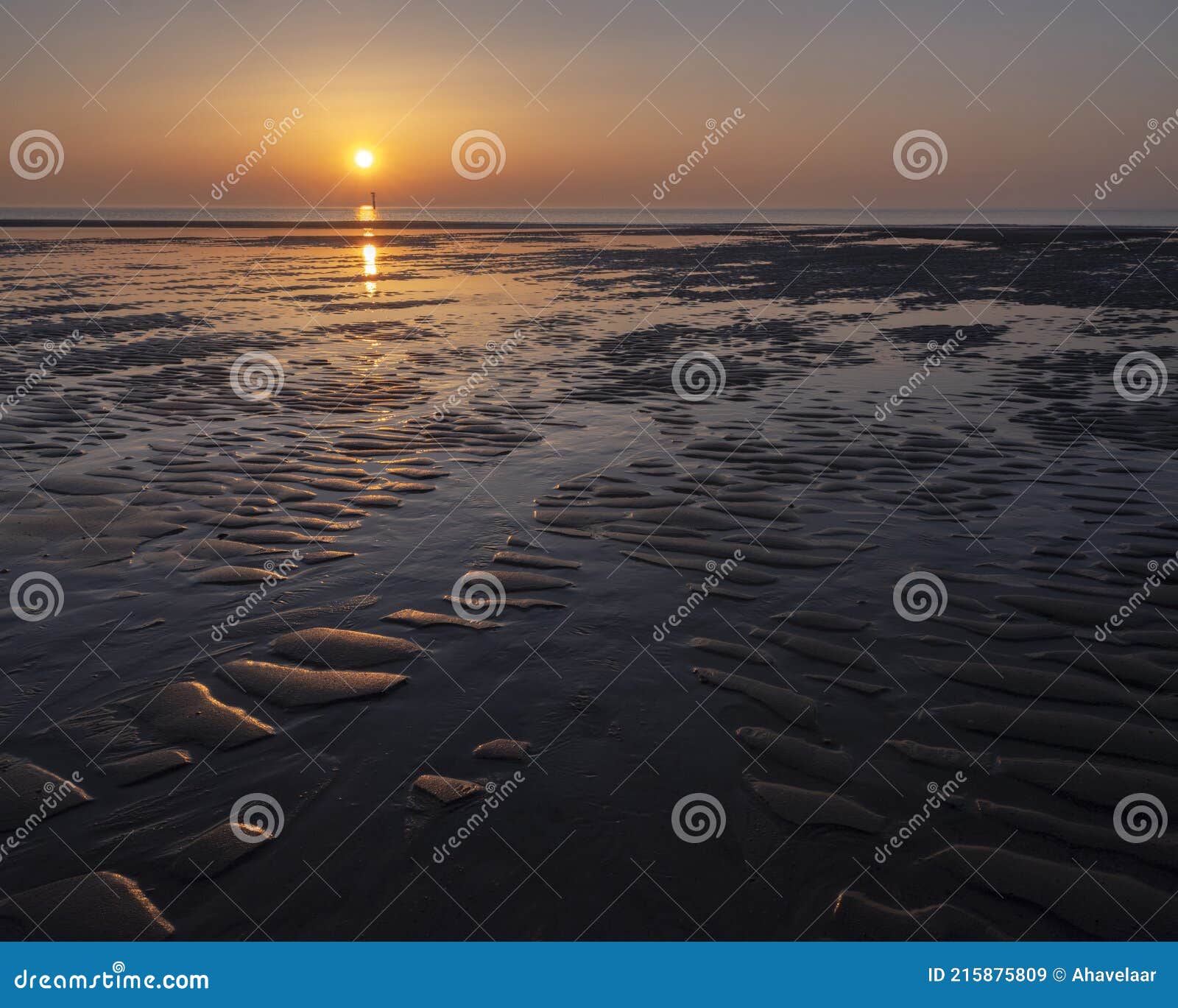 Pattern in Sand and Colorful Reflection of Setting Sun in Water Stock ...