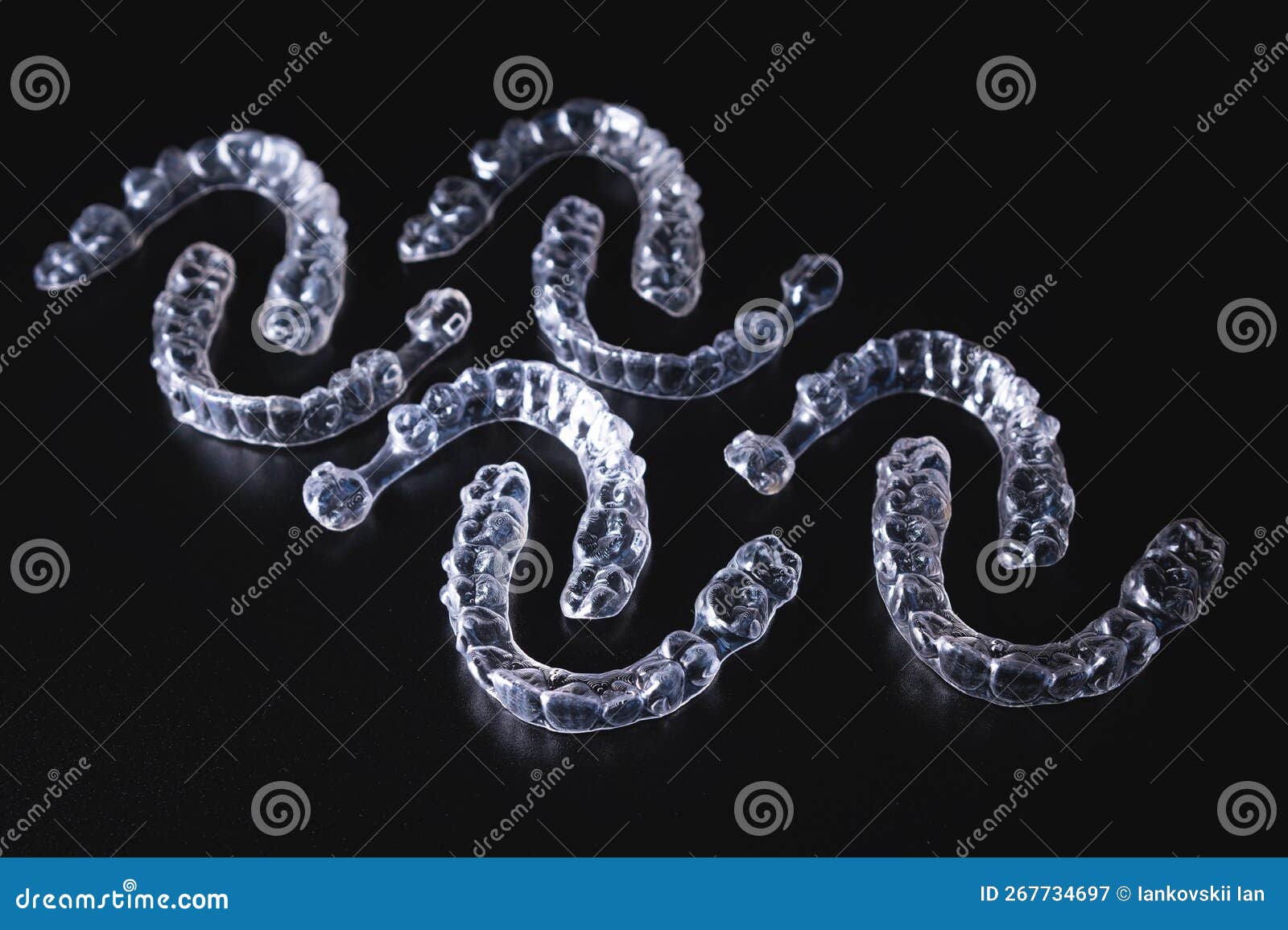 Pattern of Transparent Aligners, Invisible Braces Lies on a Black ...
