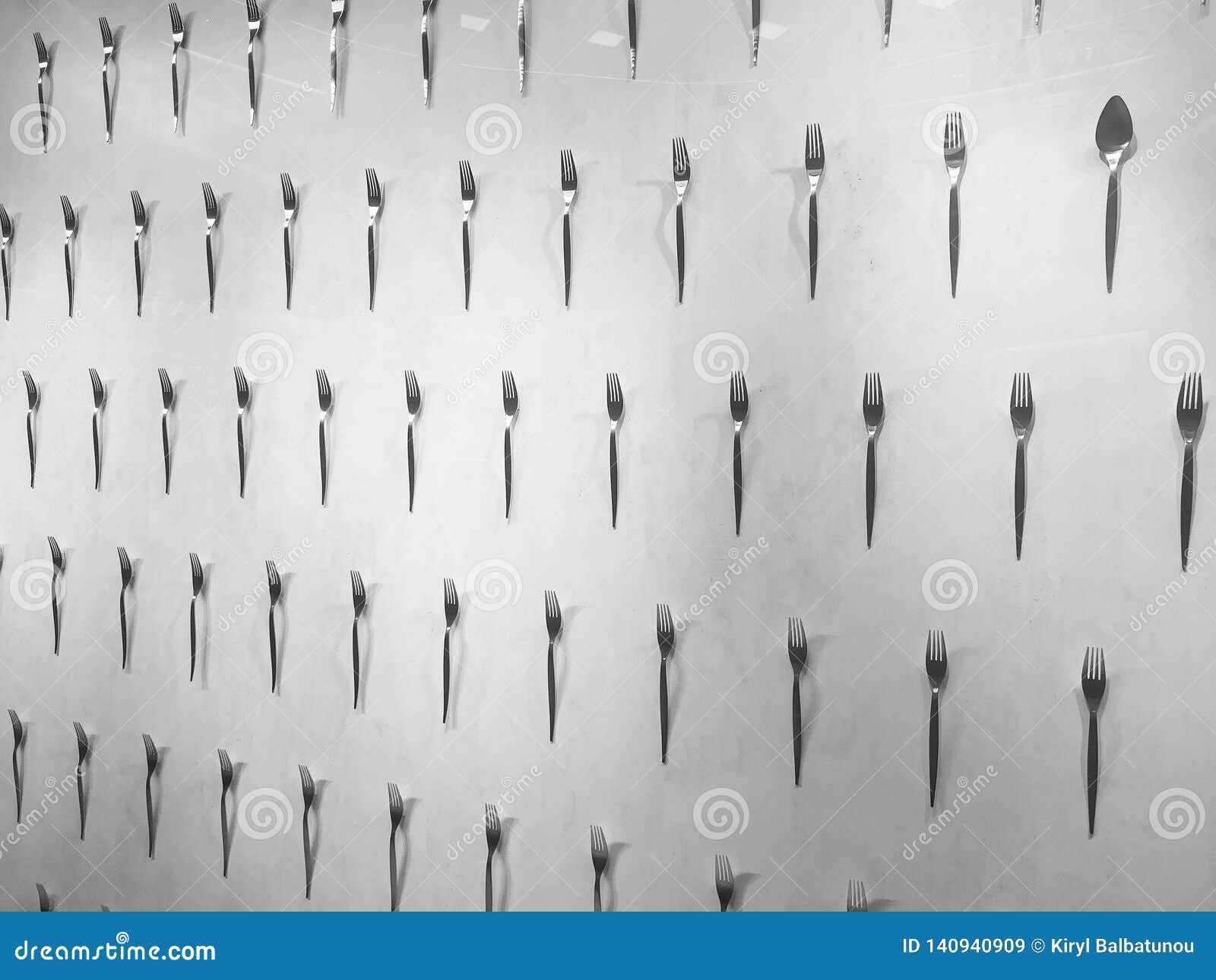 The Pattern of a Variety of Metal Forks, Cutlery on the Wall on a Black ...