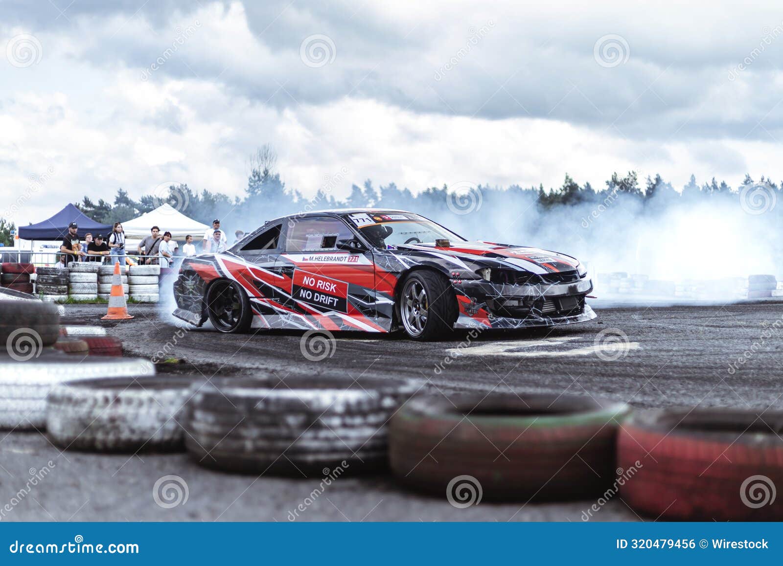 Patterned Race Car Taking a Turn on a Race Trick with Visible Smoke ...