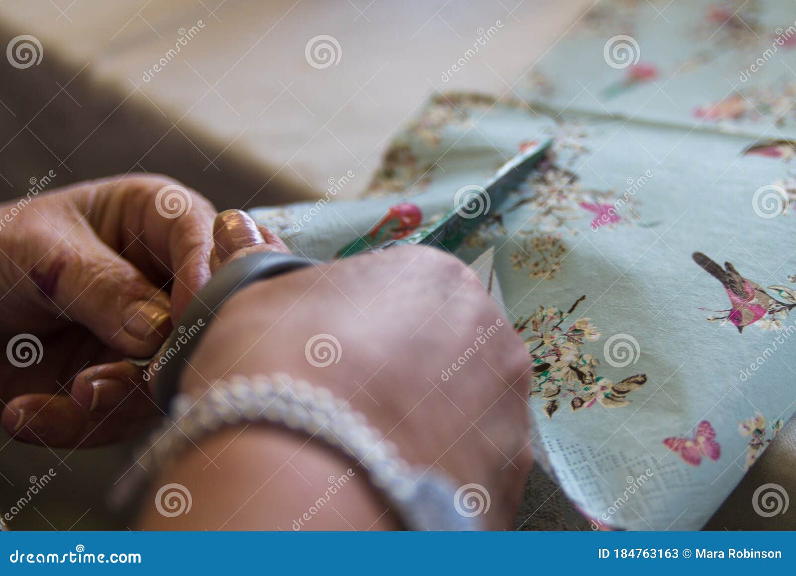 Patterned Tissue Paper Being Cut with Scissors Ready for Use in a ...