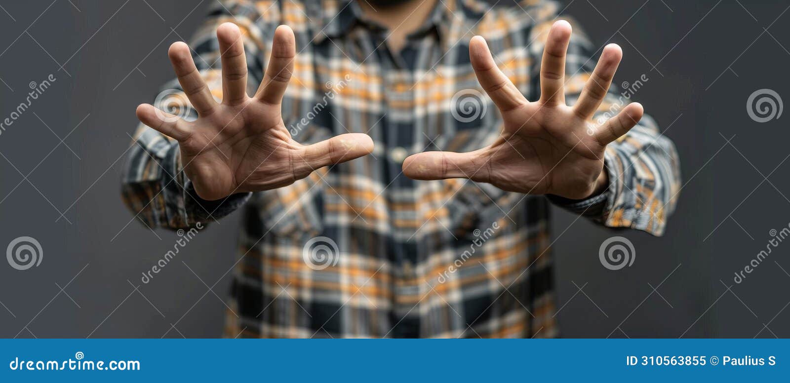 Pausing Time: a Man Demonstrating the Stop Timeout Gesture on a Gray ...