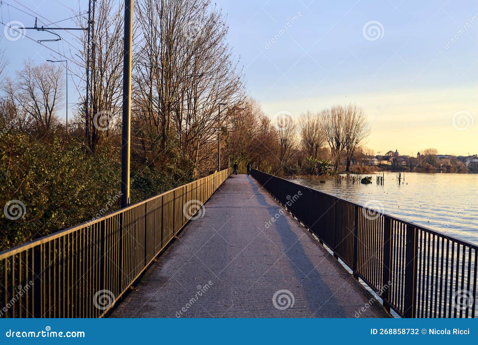 Paved Footbridge in a Park Over a Lake at Sunset Stock Photo - Image of ...