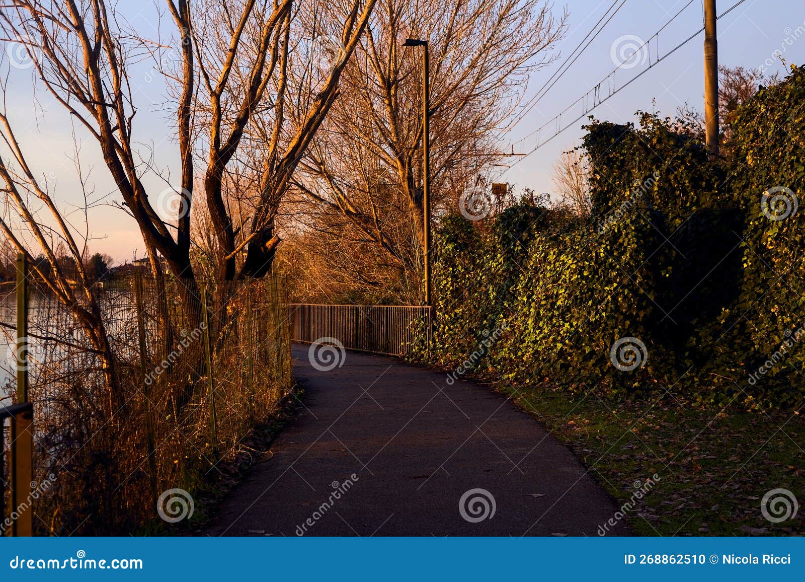 Paved Footbridge in a Park Over a Lake at Sunset Stock Photo - Image of ...