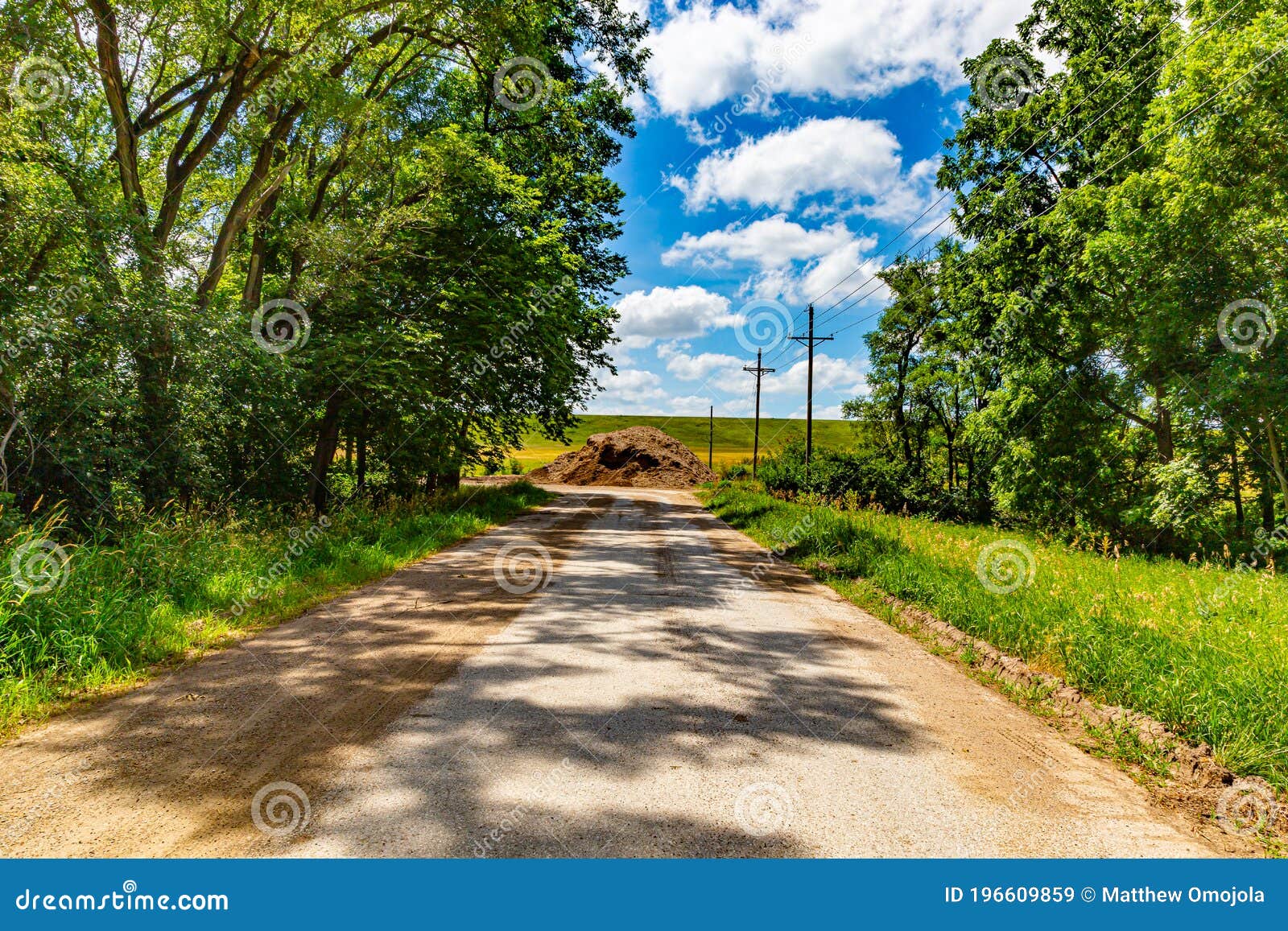 Paved Path with Forest on Either Side. Blue Sky and Clouds Stock Image ...
