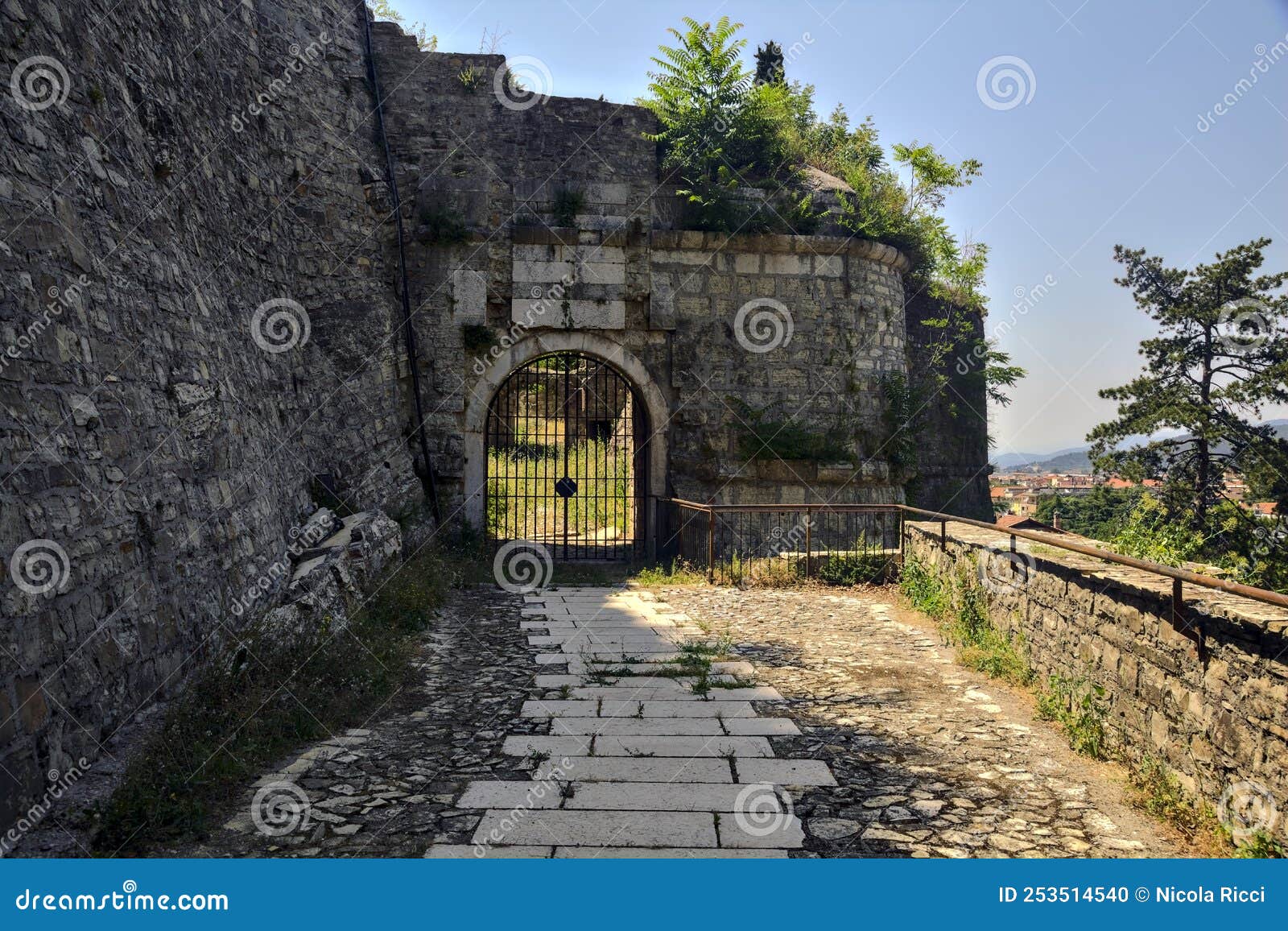 Paved Path that Leads To a Closed Gate and a Wall Stock Photo - Image ...