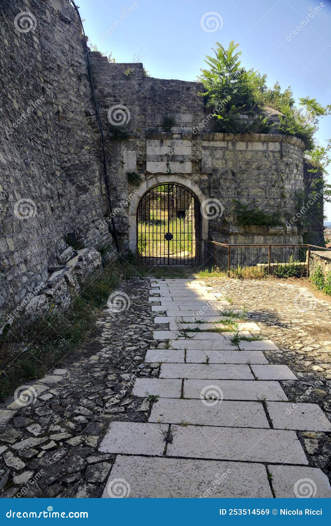Paved Path that Leads To a Closed Gate and a Wall Stock Image - Image ...