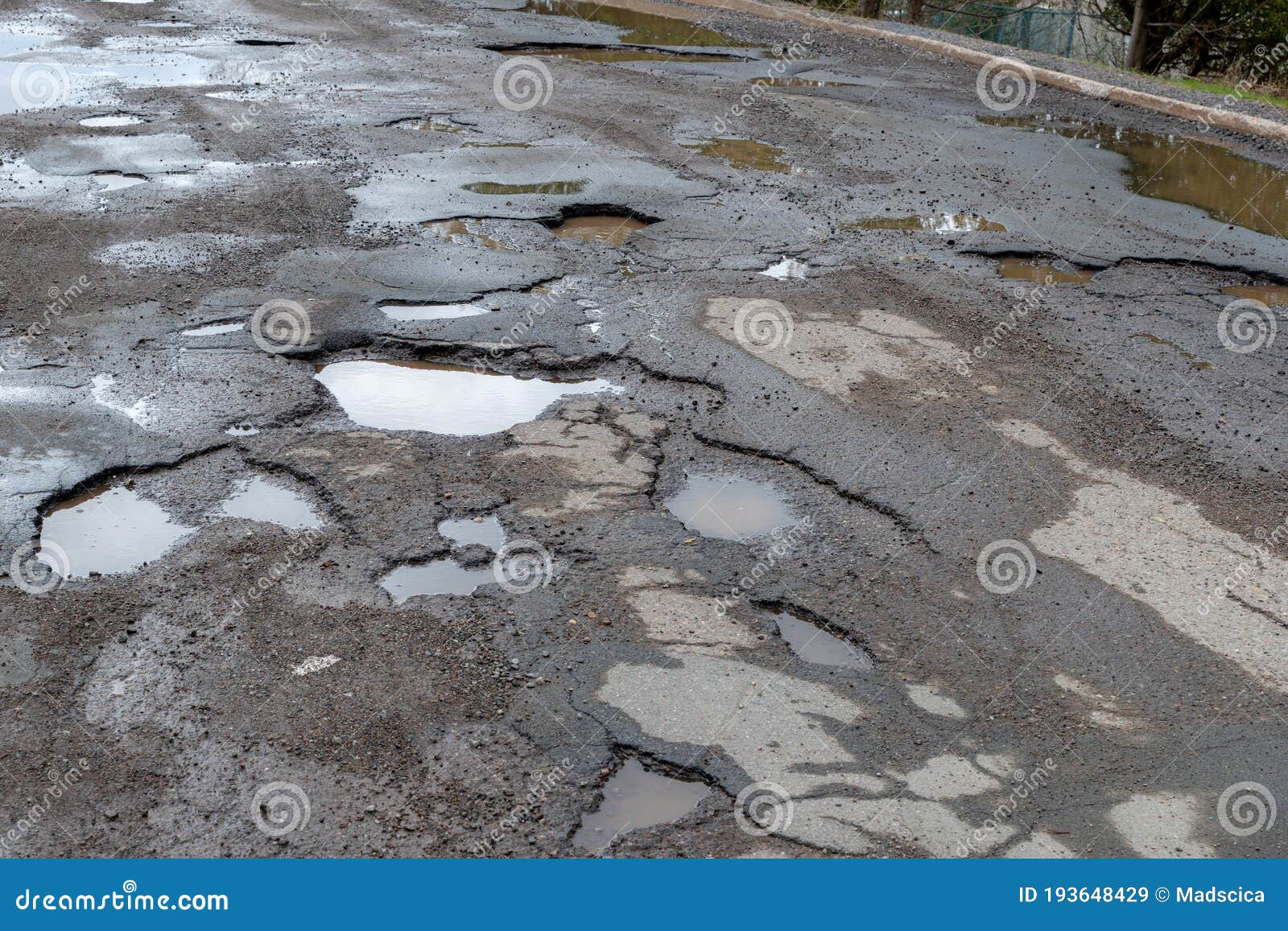A Paved Road Filled with Many Large Potholes Stock Image - Image of ...