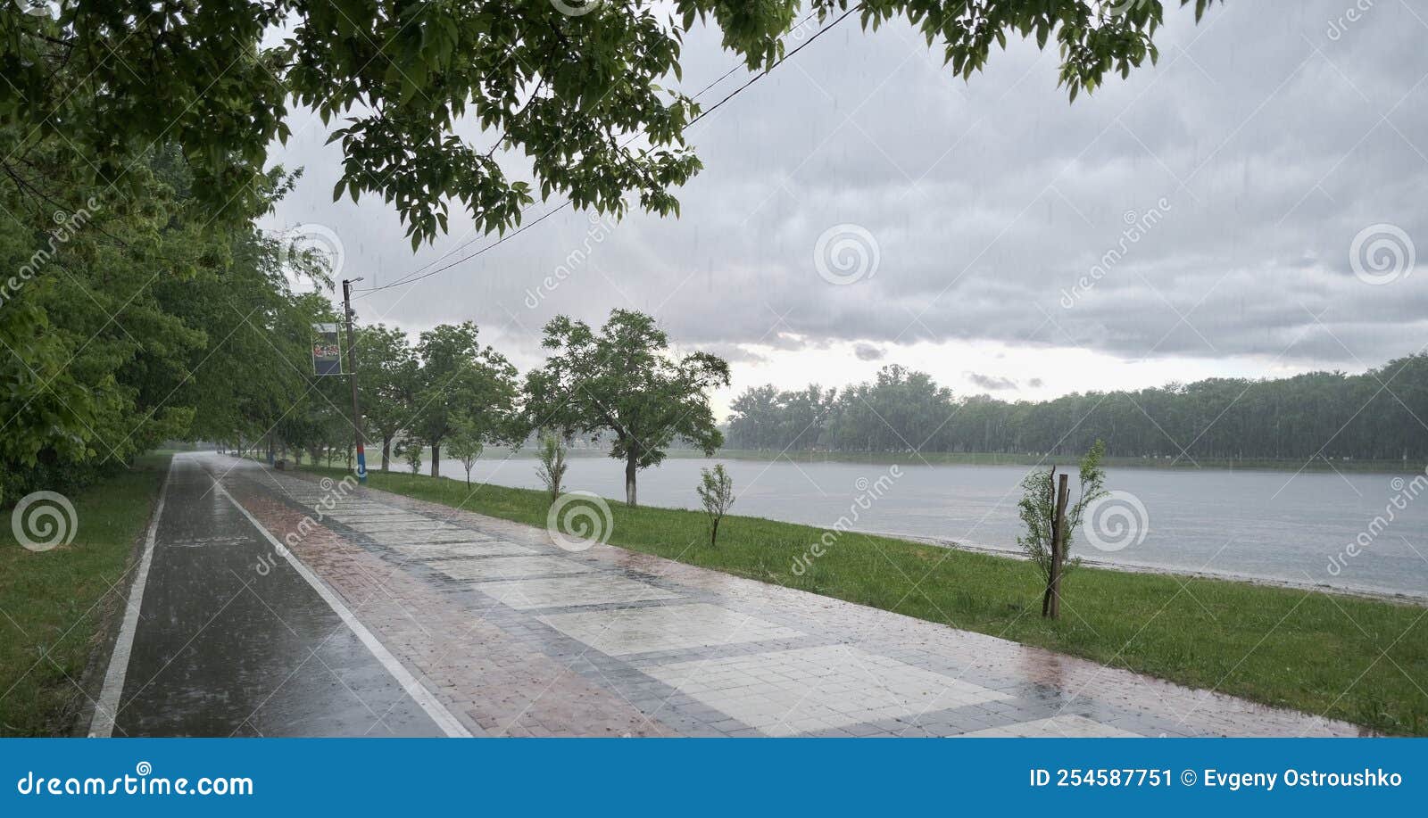Pavement Covered with Tiles during Heavy Rain on the Shore of a Lake ...