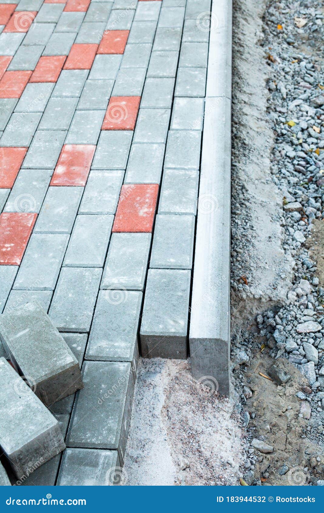 Paving the footpath stock photo. Image of laying, pavestone - 183944532