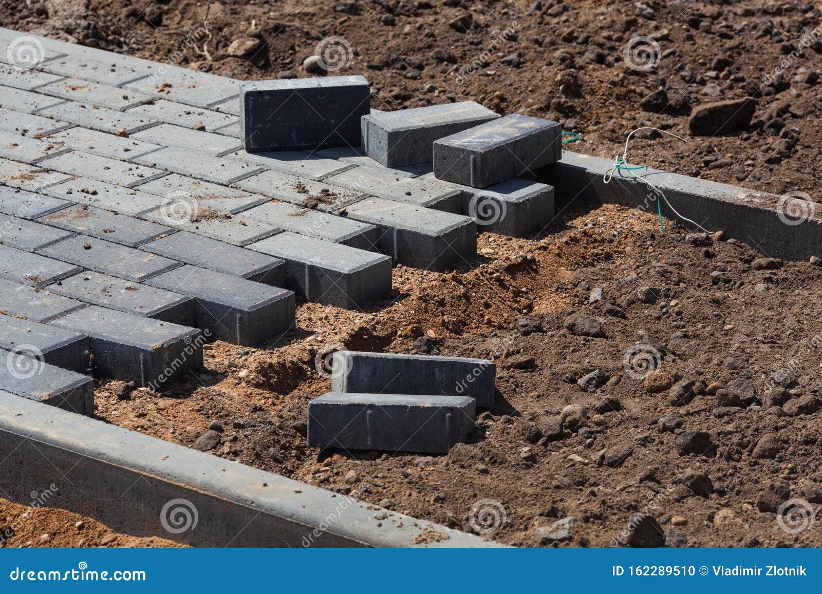 Paving of a Footpath from Paving Slabs Stock Photo - Image of repairing ...