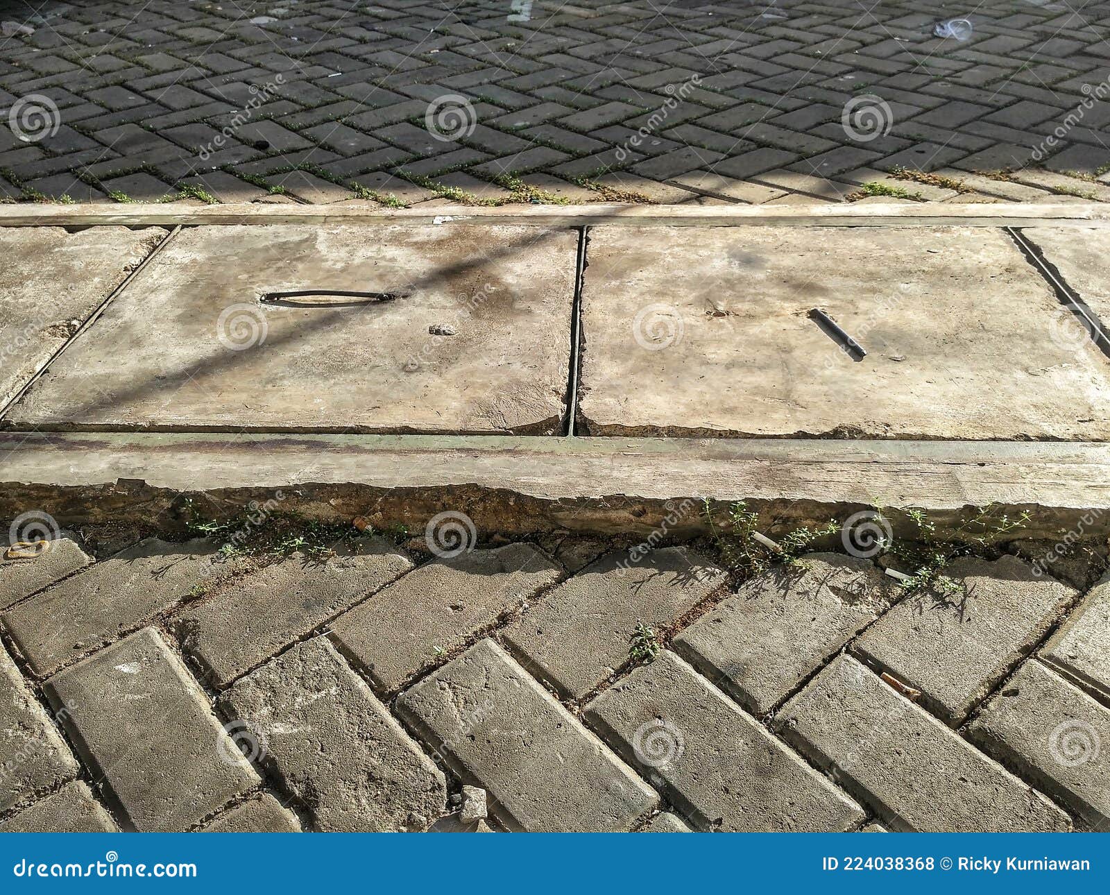 Paving Stone and Gutter Cover in a Parking Lot Stock Photo - Image of ...