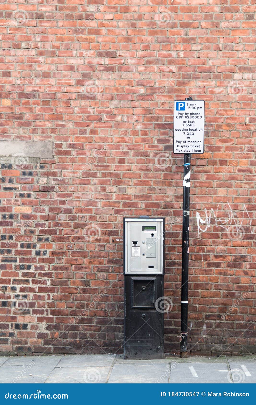 Pay and Display Parking Meter with Information Sign on a Pole in Front ...