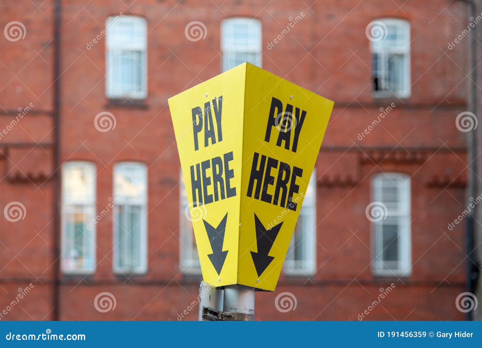 A Pay Here Sign on Top of a Pay and Display Ticket Car Park Machine ...