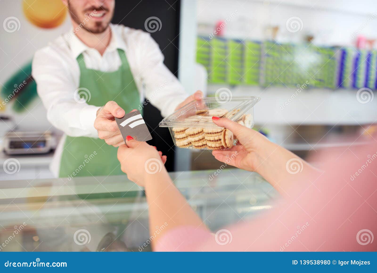 Paying for box of cookies stock photo. Image of indoor - 139538980