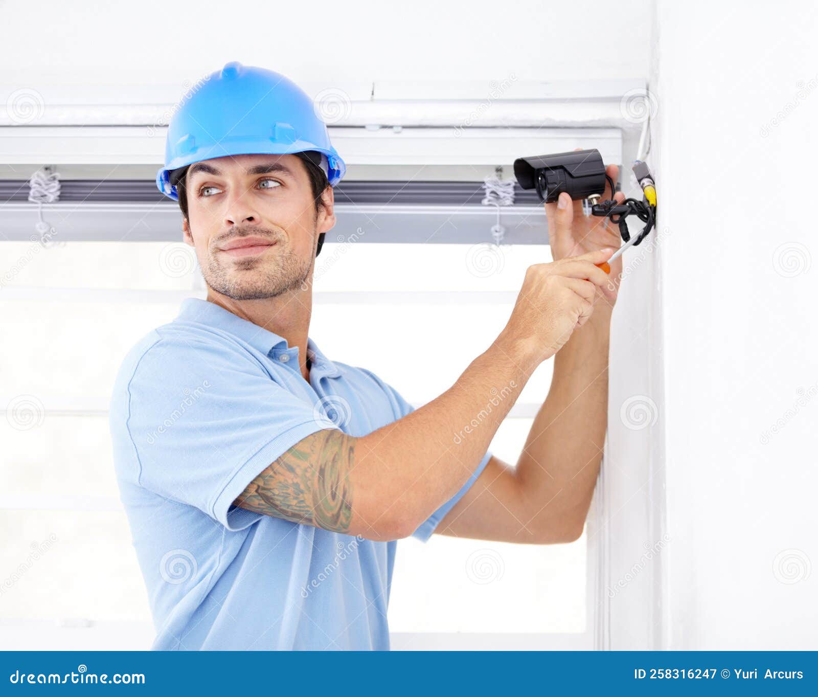 Peace of Mind Guaranteed. a Handsome Young Man Installing a Security ...