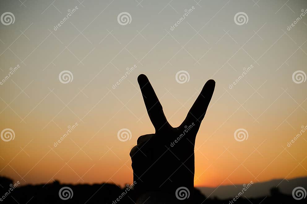 A Peace Sign Hand Gesture is Silhouetted Stock Photo - Image of ...