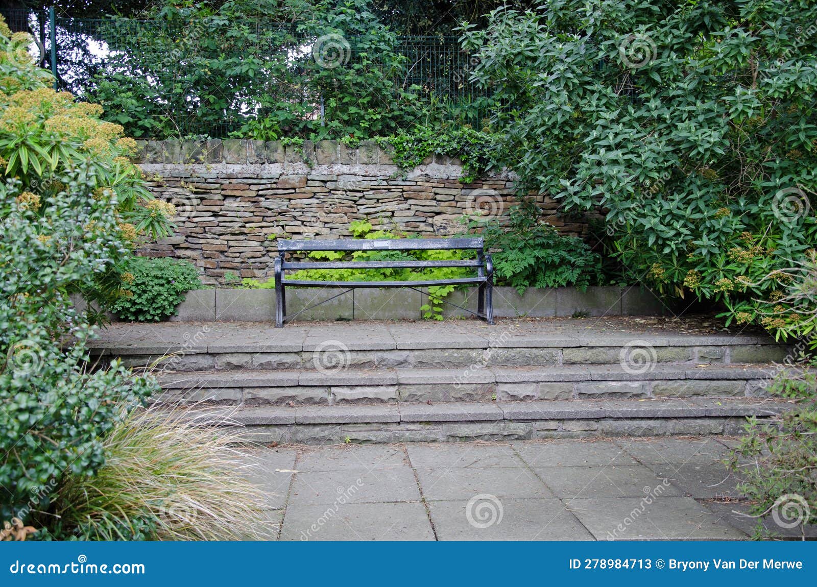 Peaceful bench in a garden stock image. Image of stone - 278984713