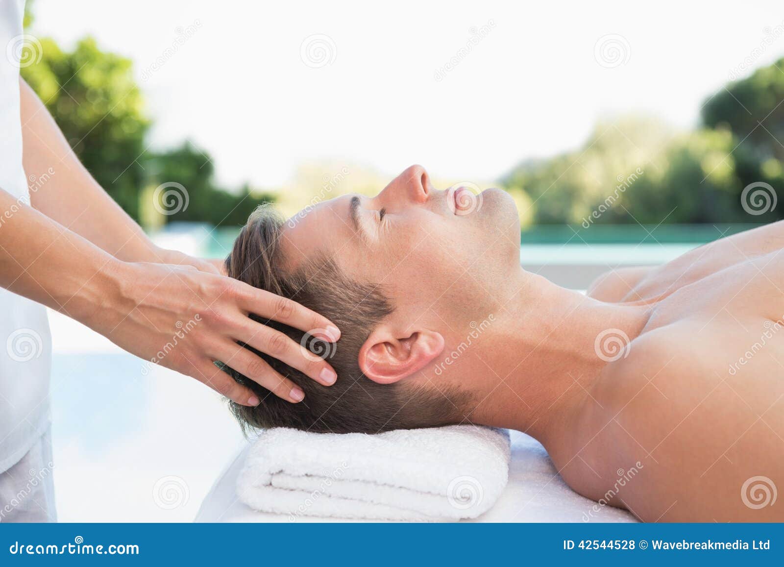 Peaceful Man Getting a Head Massage Poolside Stock Photo - Image of ...