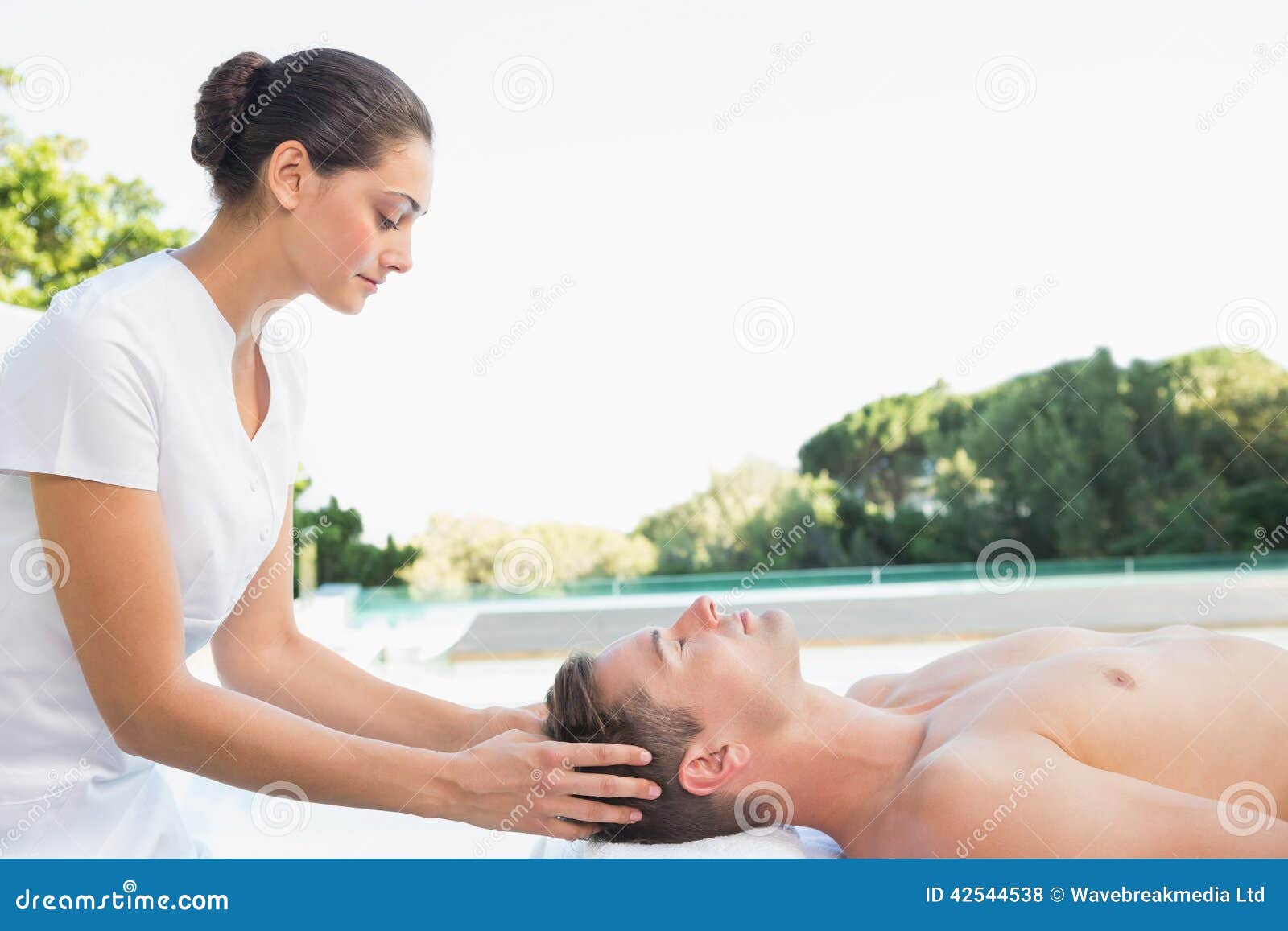 Peaceful Man Getting a Head Massage Poolside Stock Photo - Image of ...