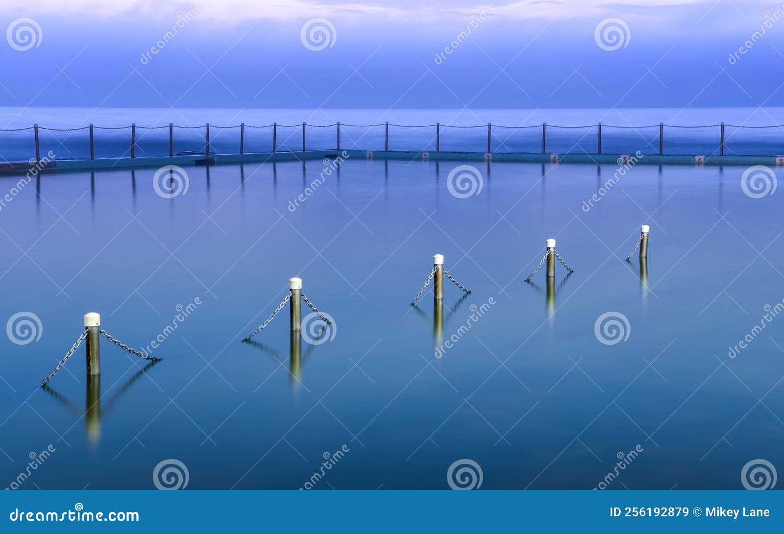 A Peaceful Setting with Smooth Water and Reflections of Chains in an ...