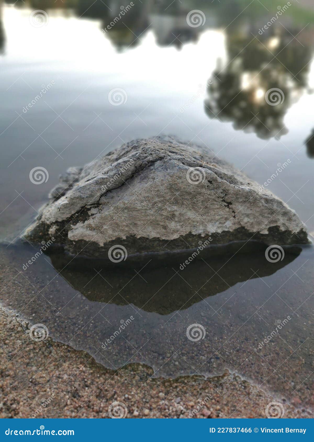 A Rock on Water with Reflection Stock Photo - Image of wave, beach ...