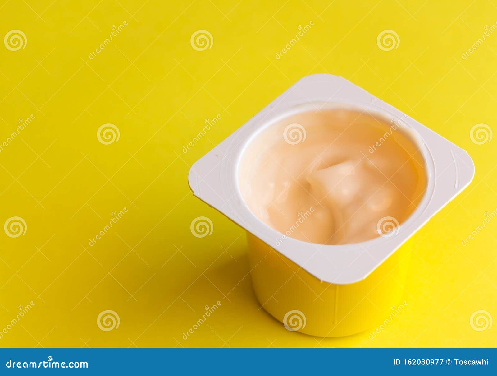 Peach Flavoured Yogurt in Yellow Plastic Cup Isolated on Bright Yellow ...
